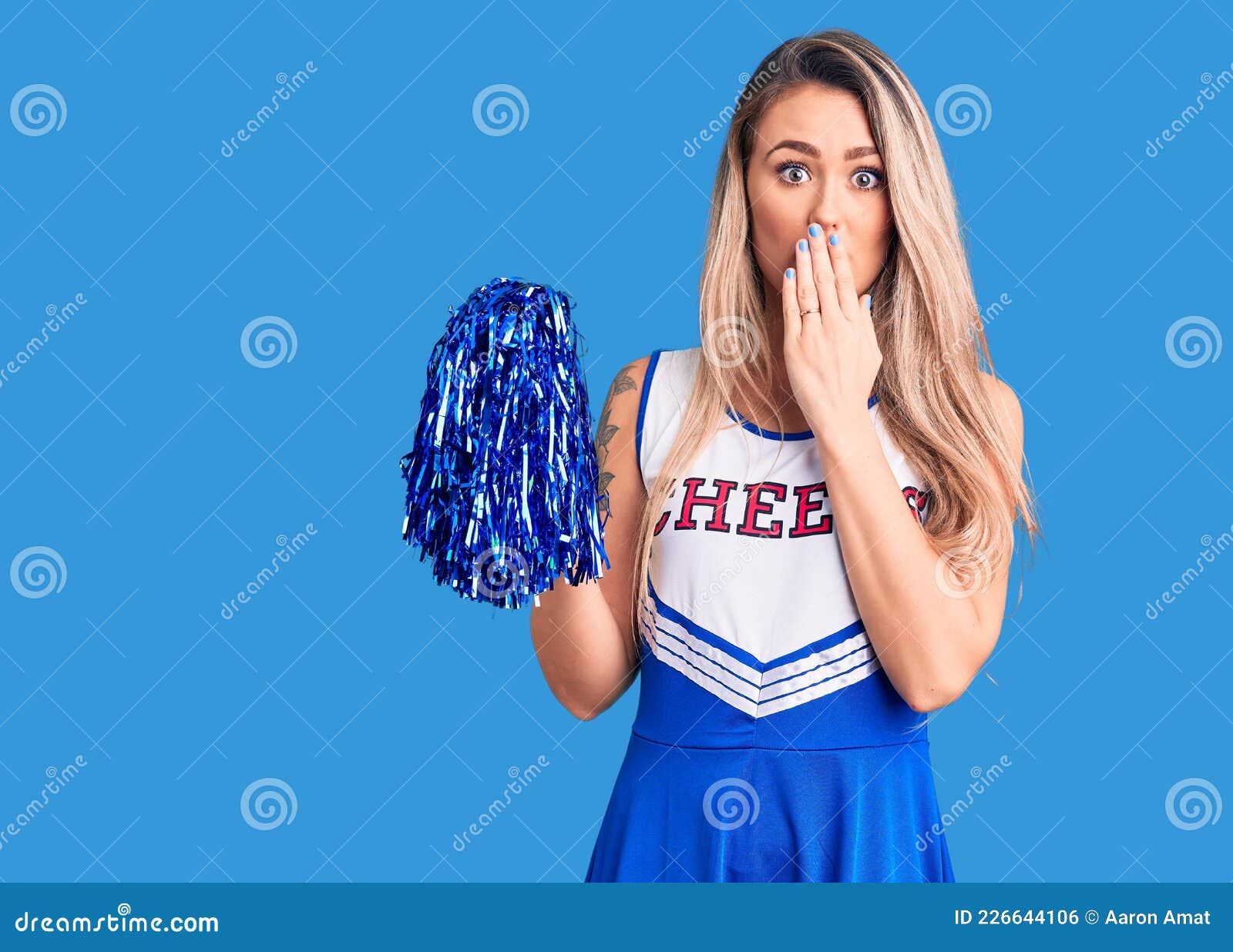 Young Beautiful Blonde Woman Wearing Cheerleader Uniform Holding Pompom