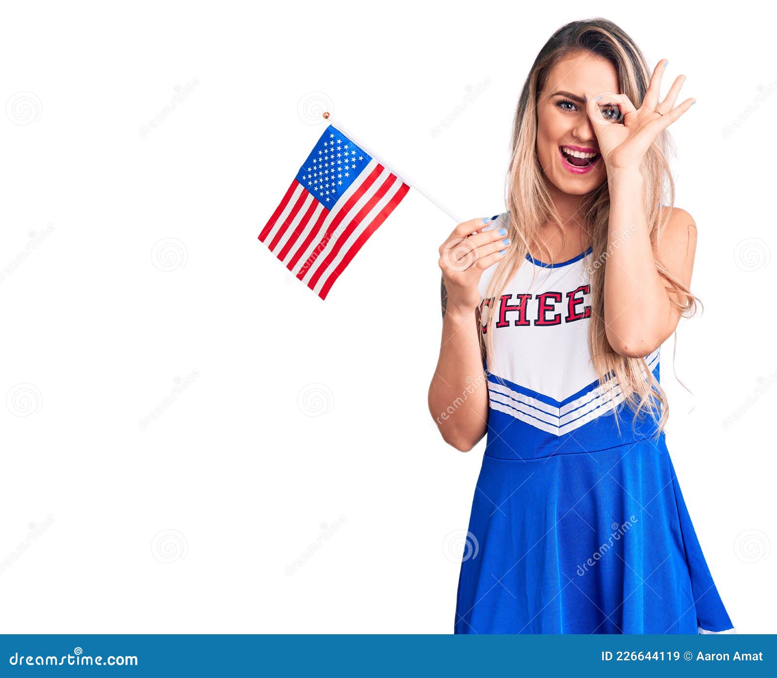Young Beautiful Blonde Woman Wearing Cheerleader Uniform Holding United