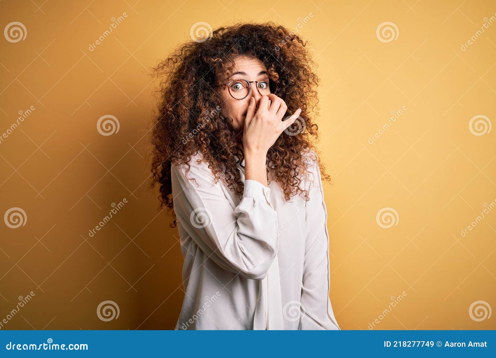 Young Beautiful Brunette Woman With Curly Hair And Piercing Wearing