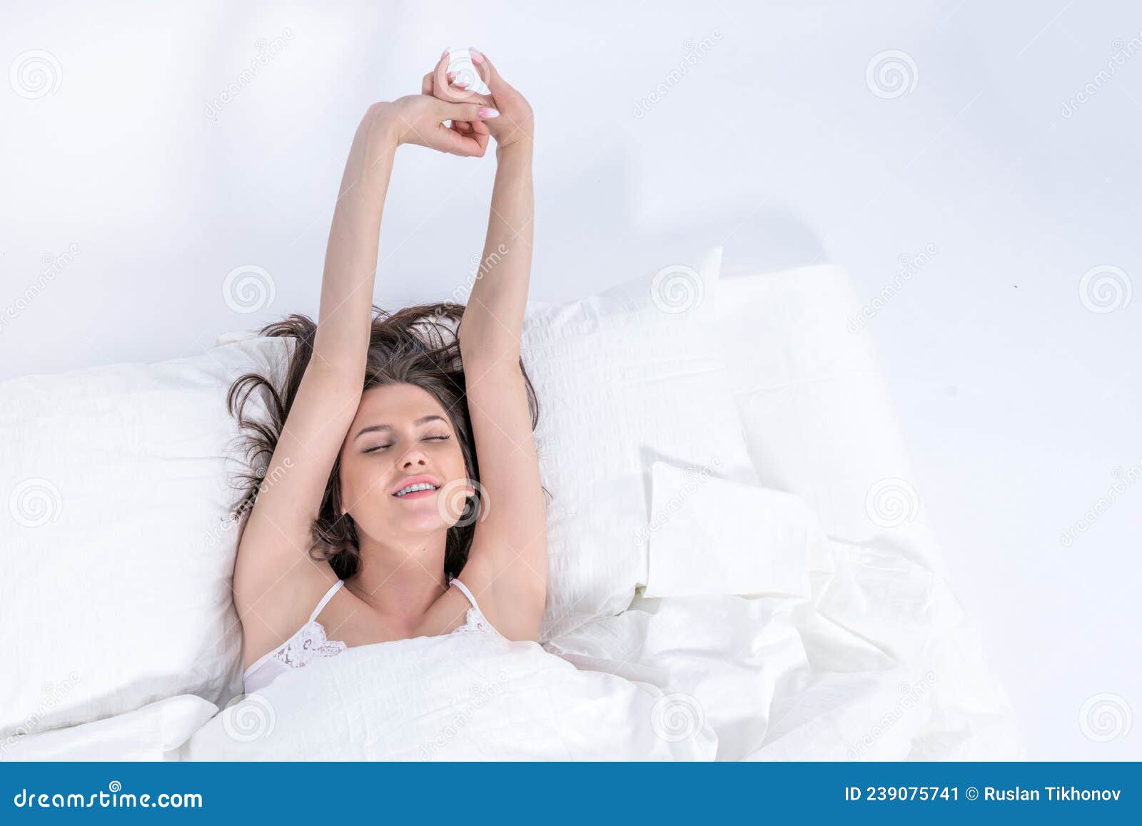 A Young Beautiful Brunette Woman Wakes Up In Her Bed Fully Rested