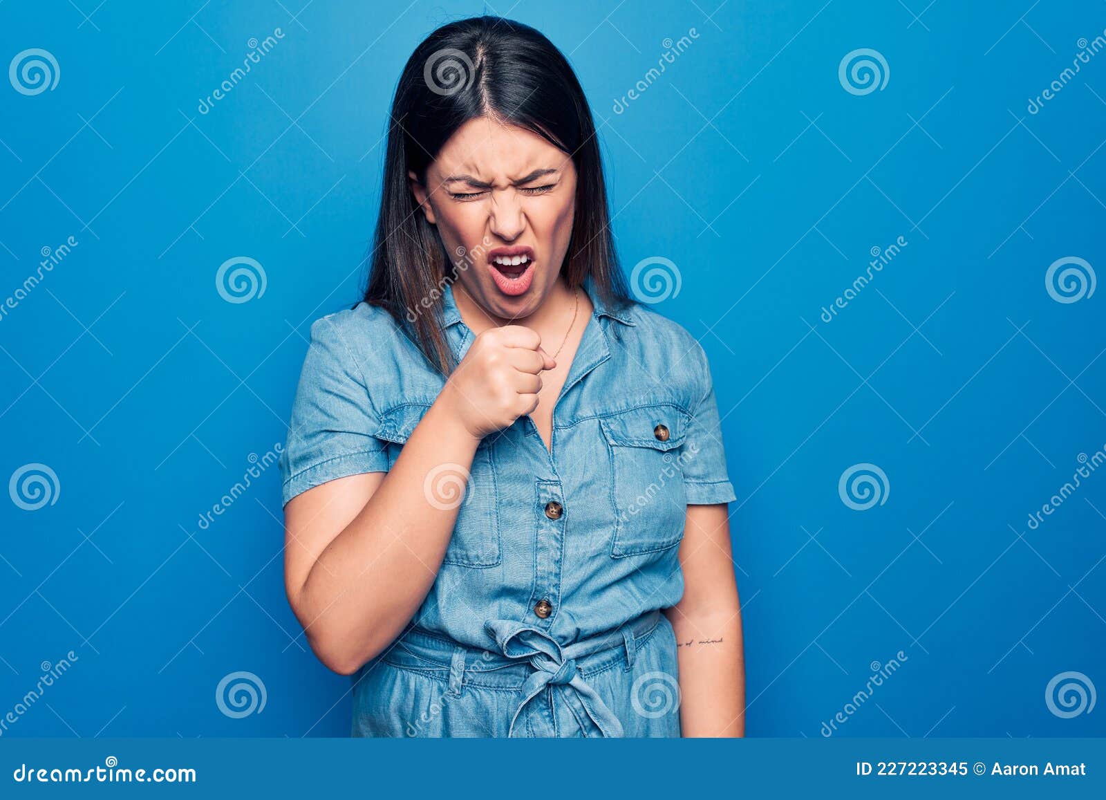 Young Beautiful Brunette Woman Wearing Casual Denim Dress Over Isolated