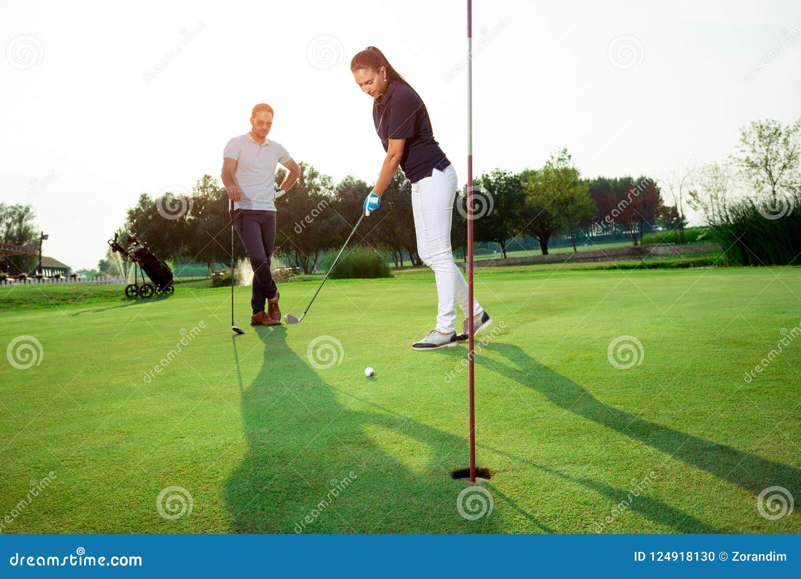 Young Couple Enjoying Time on a Golf Course Stock Photo - Image of full ...
