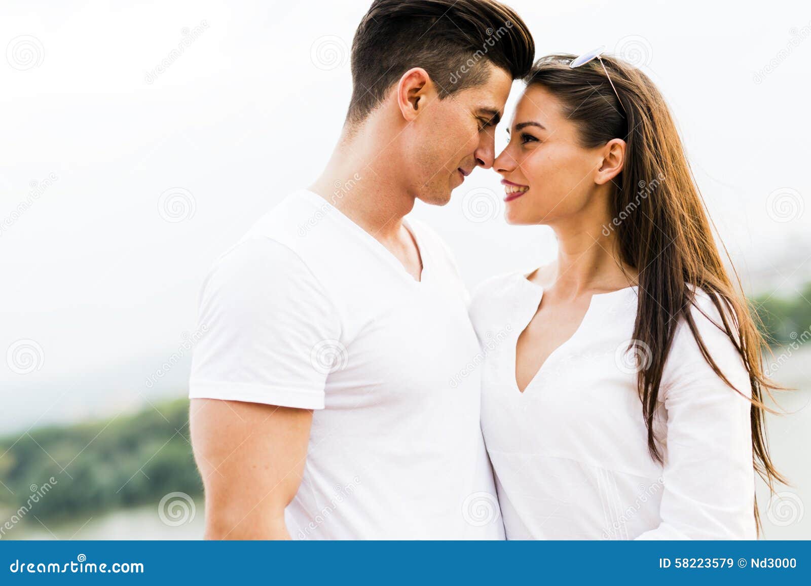 Young Beautiful Couple Rubbing Noses As A Sign Of Love Stock Image