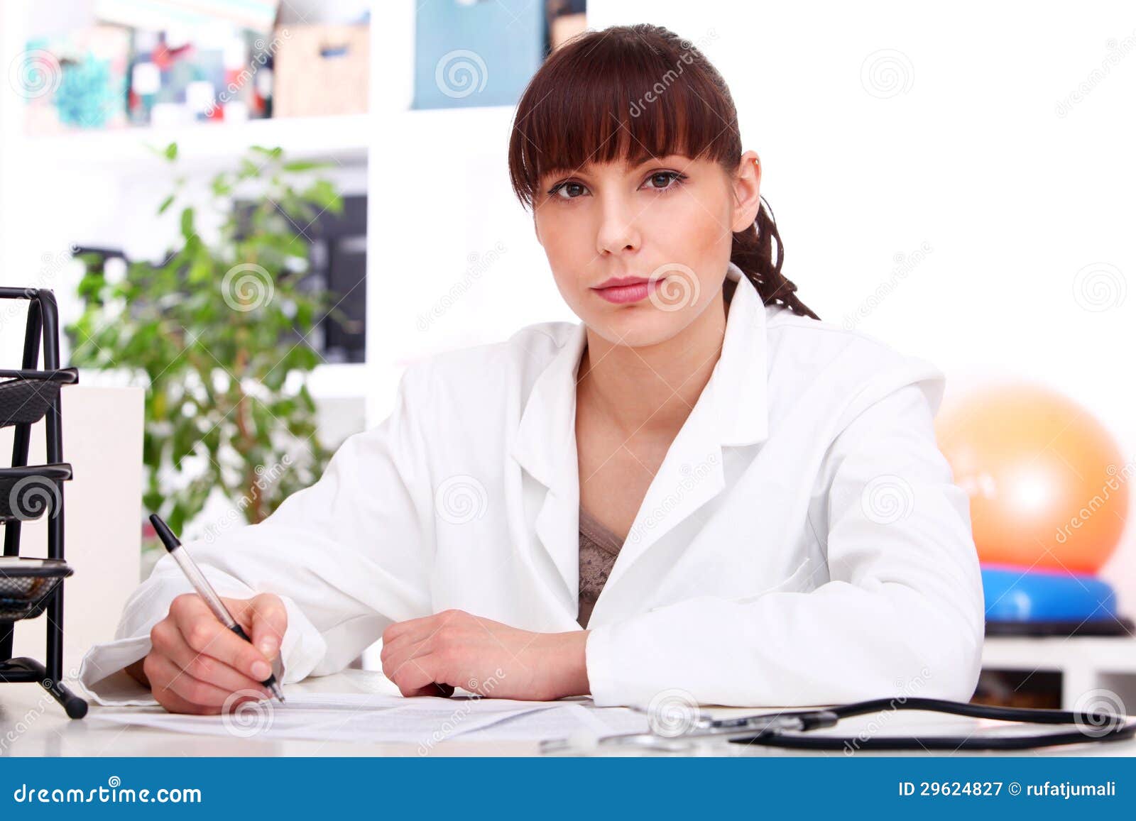 Young Beautiful Doctor at Table Stock Image - Image of looking ...
