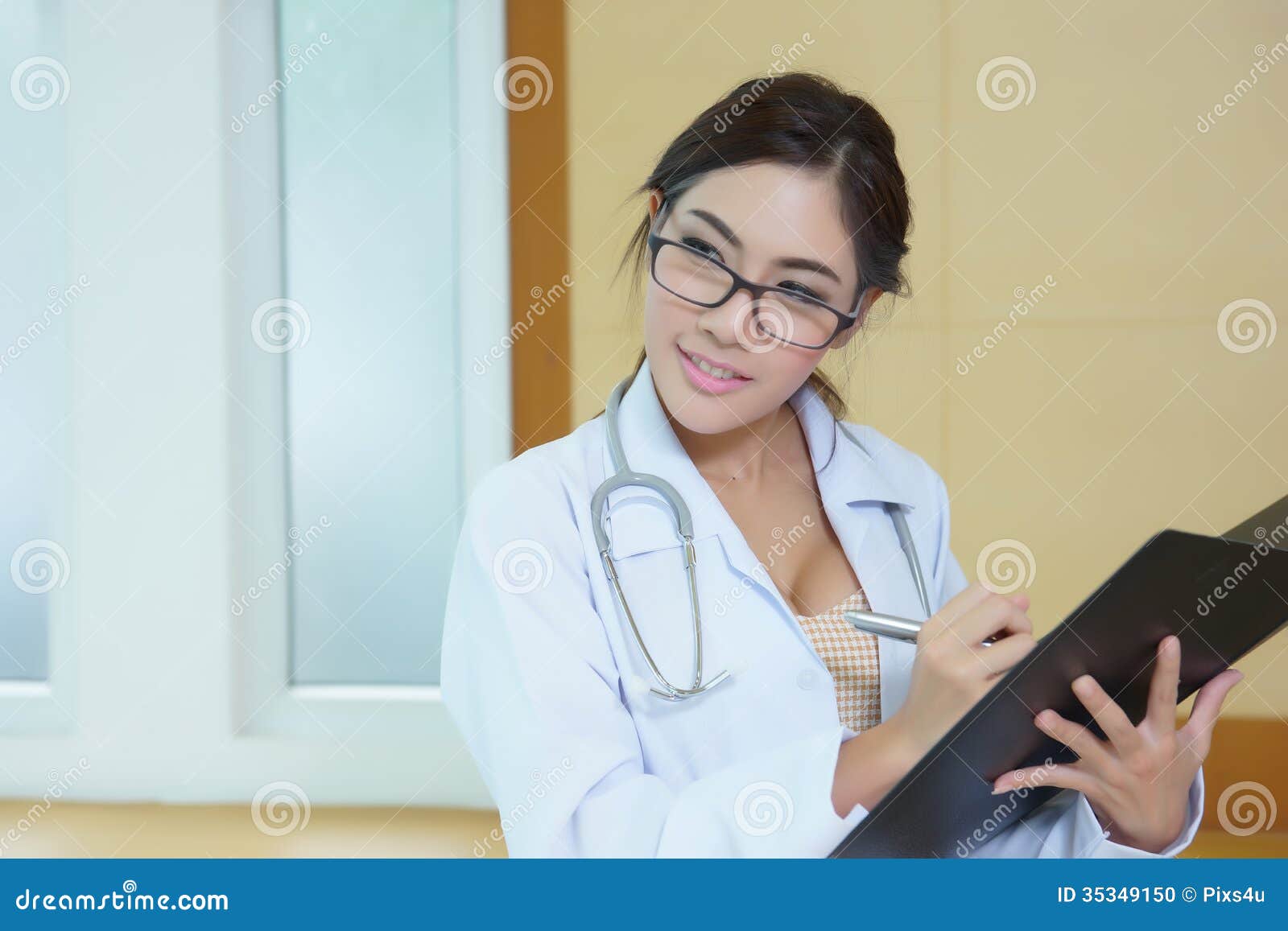 Young Beautiful Doctor Writing on Folder Stock Photo - Image of ...