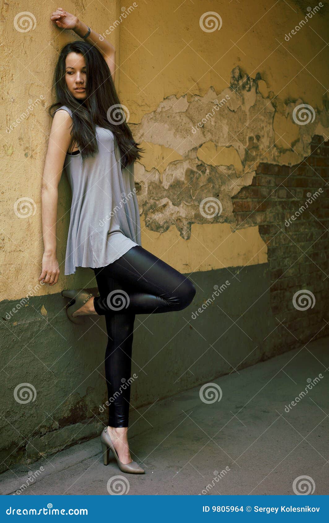 Young Beautiful Female Model Standing Near Wall Stock Photo - Image of ...