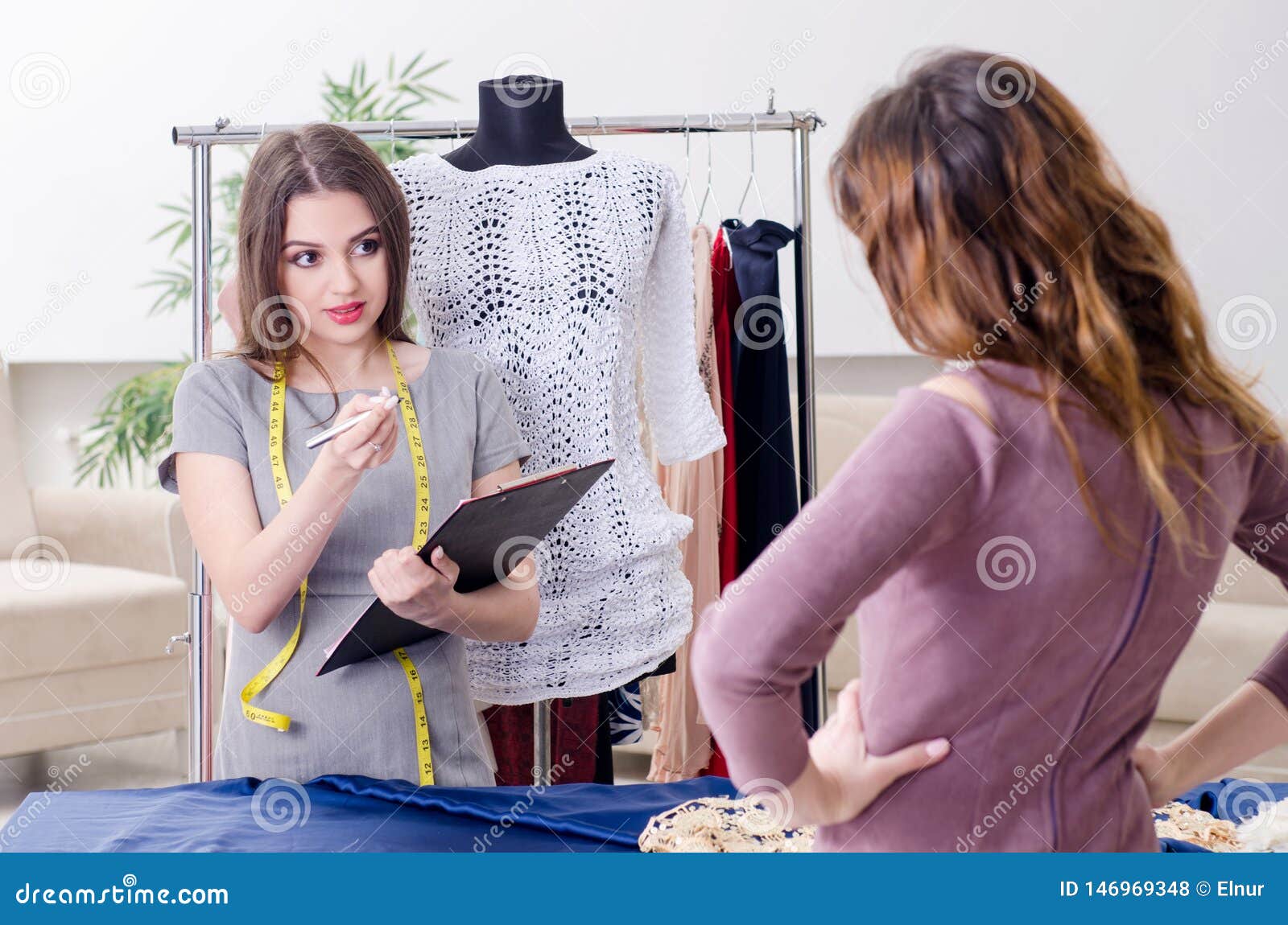 The Young Beautiful Female Tailor Taking Measurements Stock Photo ...