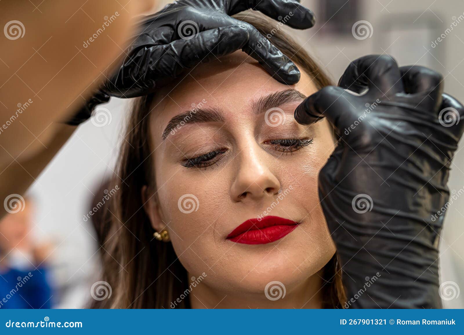 Young Beautiful Girl Client in the Salon Where the Master Corrects ...