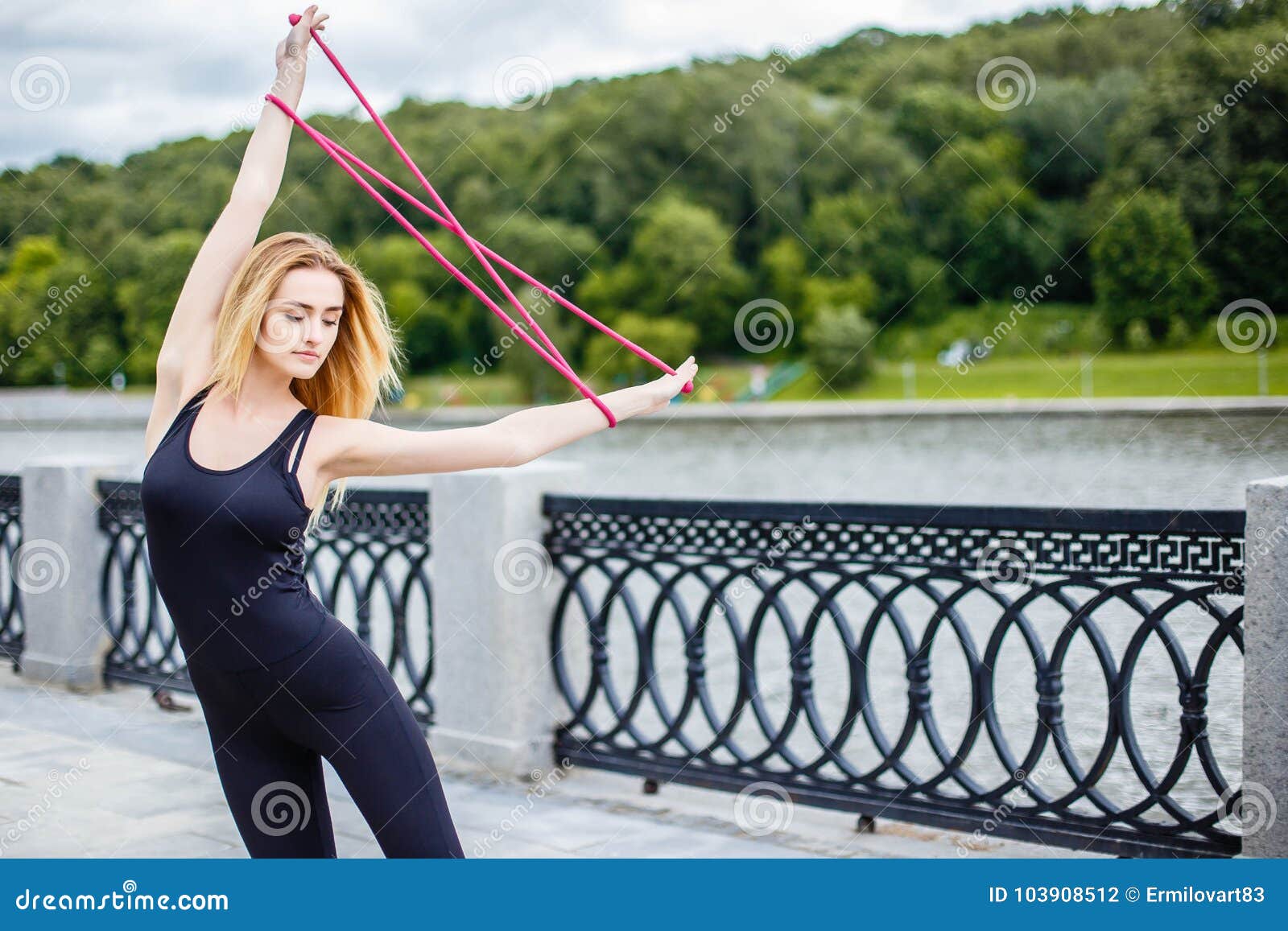 Young Beautiful Girl Doing Gymnastic Exercises Outdoors. Stock Photo ...