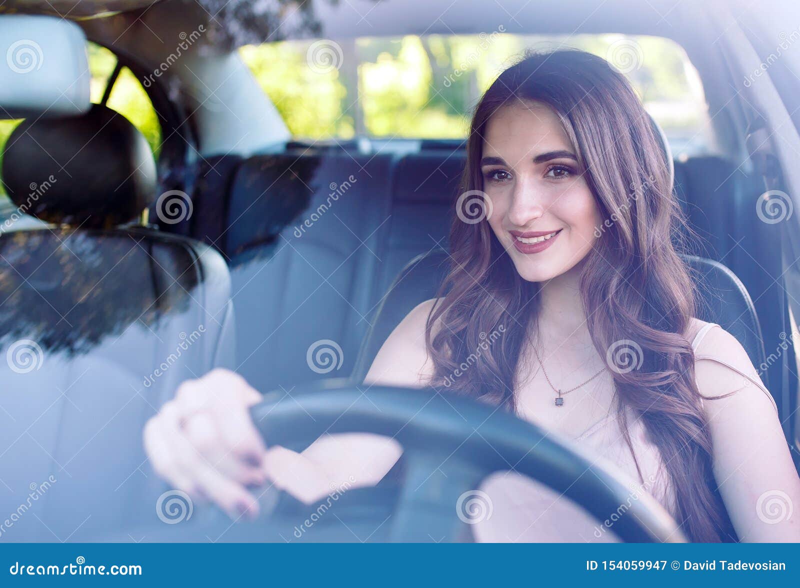 A Young Beautiful Girl is Driving a Car. Stock Image - Image of ...