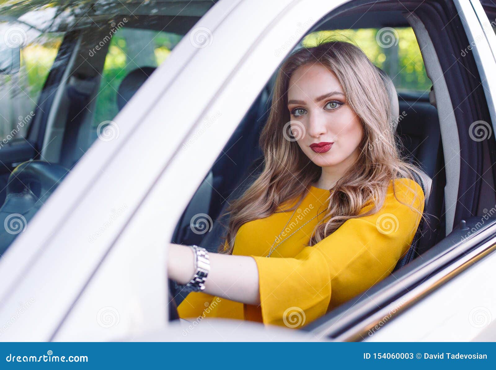 A Young Beautiful Girl is Driving a Car. Stock Image - Image of buyer ...
