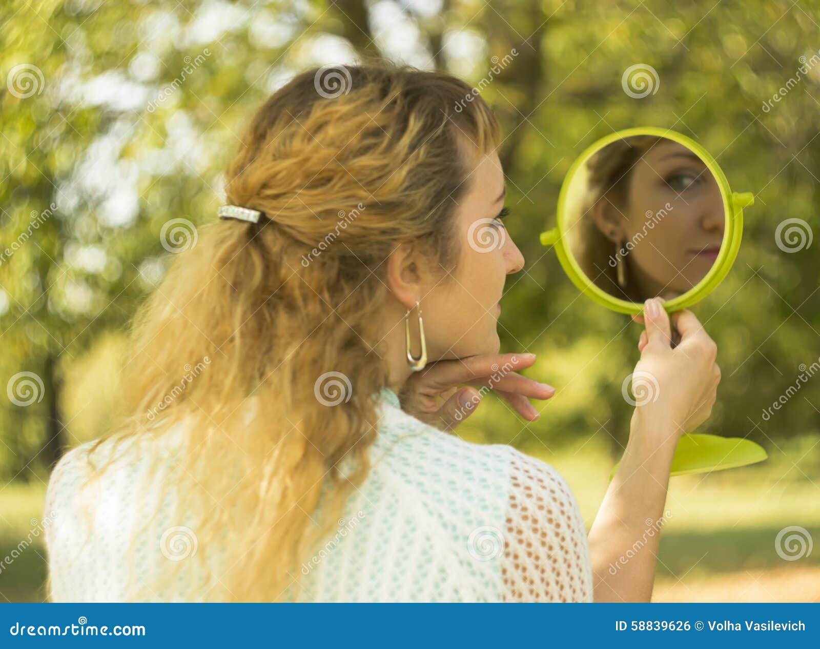 Young Beautiful Girl Look into Mirror in the Park.Soft and Blur ...