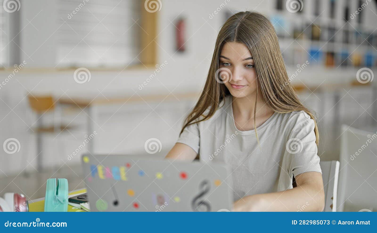 Young Beautiful Girl Student Using Laptop Studying at Library Stock ...