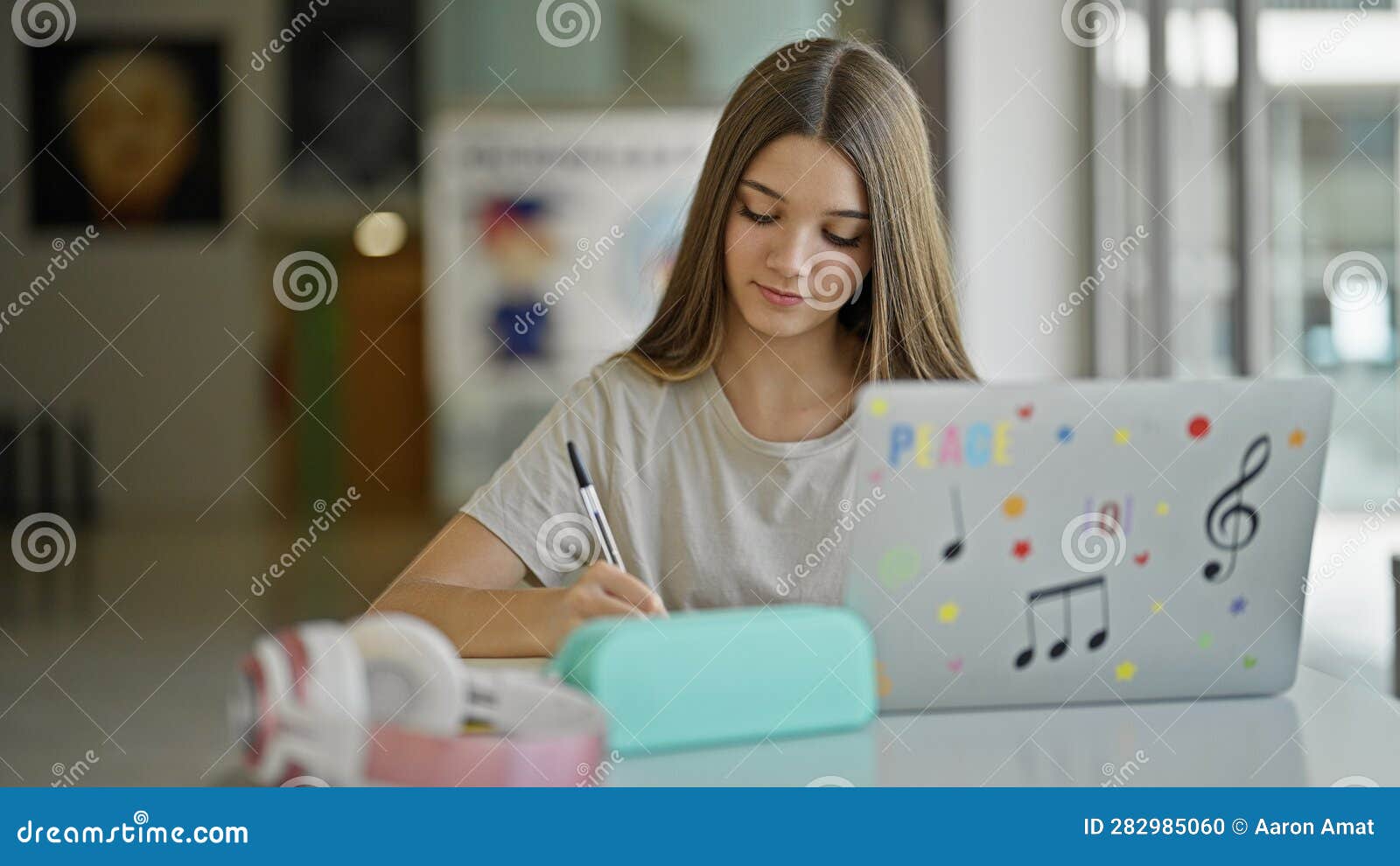Young Beautiful Girl Student Using Laptop Taking Notes at Library Stock ...