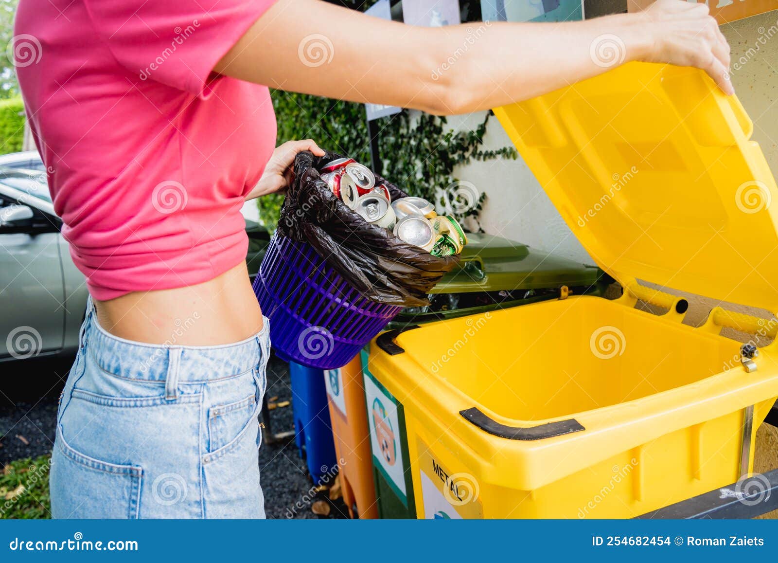 A Young Beautiful Girl Throws Sorted Garbage into Special Bins Stock ...