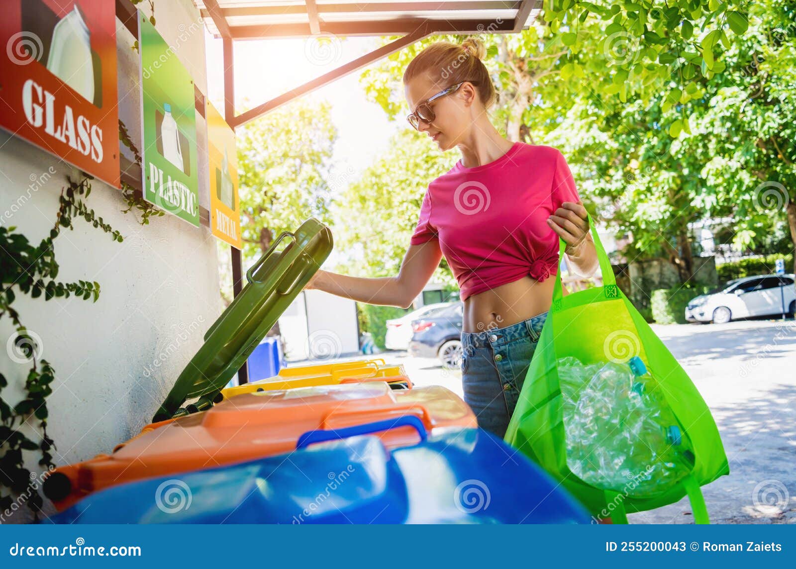 A Young Beautiful Girl Throws Sorted Garbage into Special Bins Stock ...
