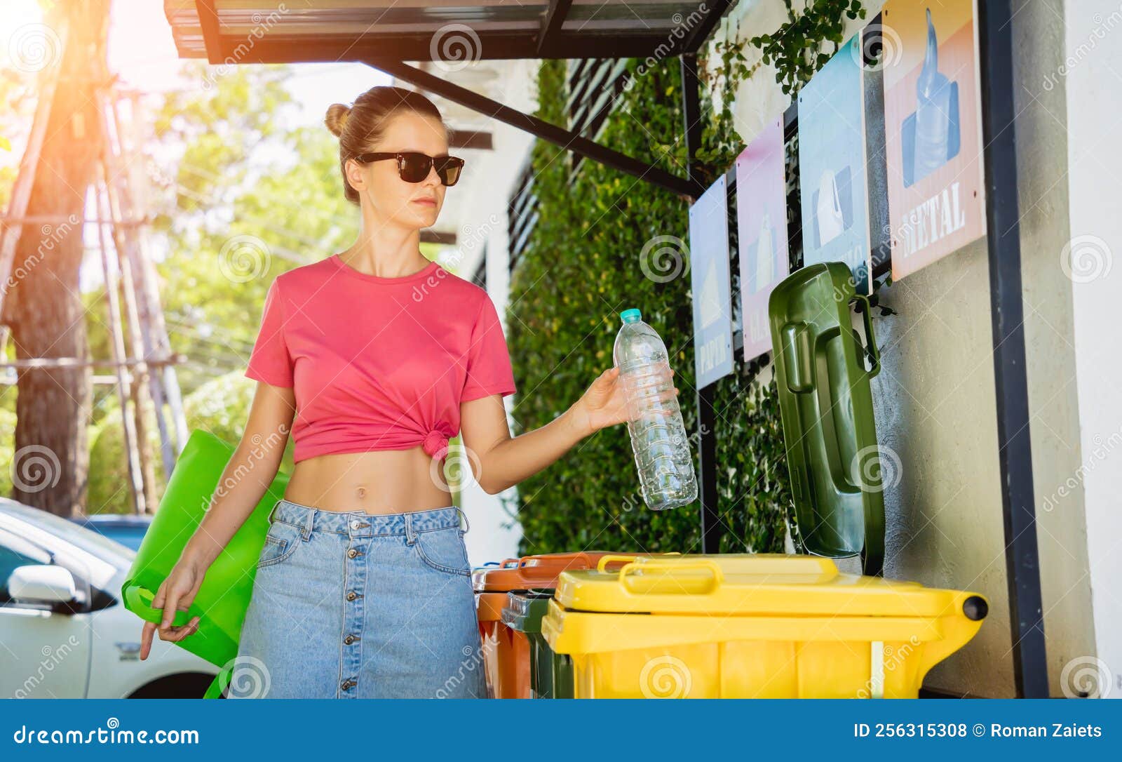 A Young Beautiful Girl Throws Sorted Garbage into Special Bins Stock ...