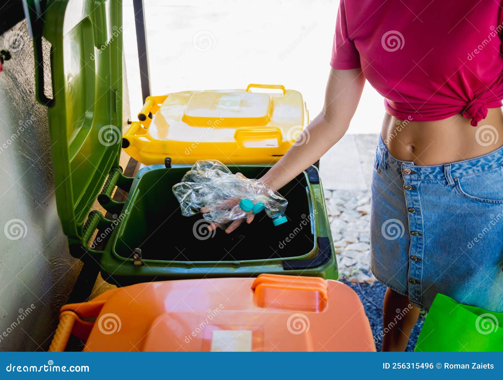 A Young Beautiful Girl Throws Sorted Garbage into Special Bins Stock ...