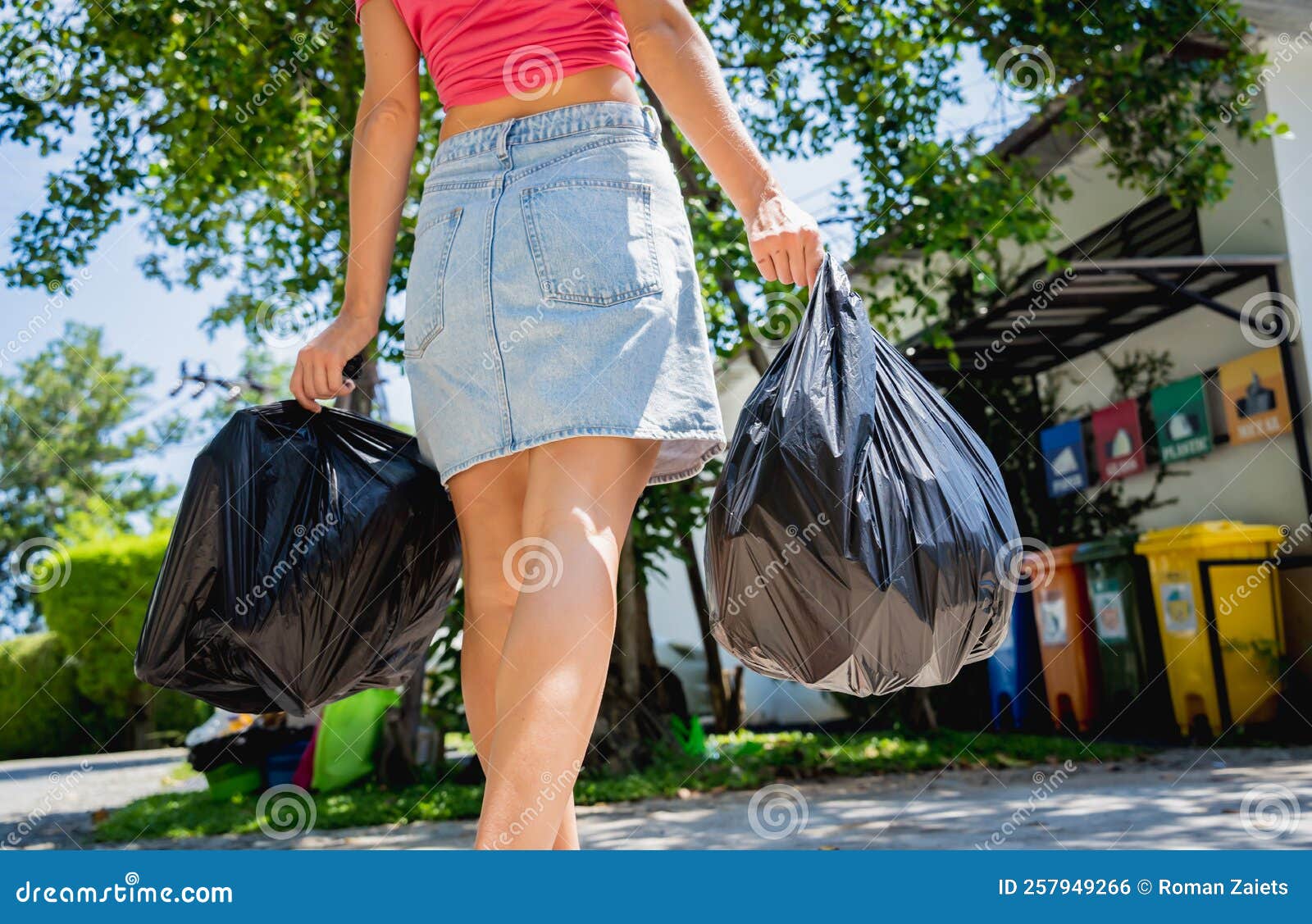 A Young Beautiful Girl Throws Sorted Garbage into Special Bins Stock ...