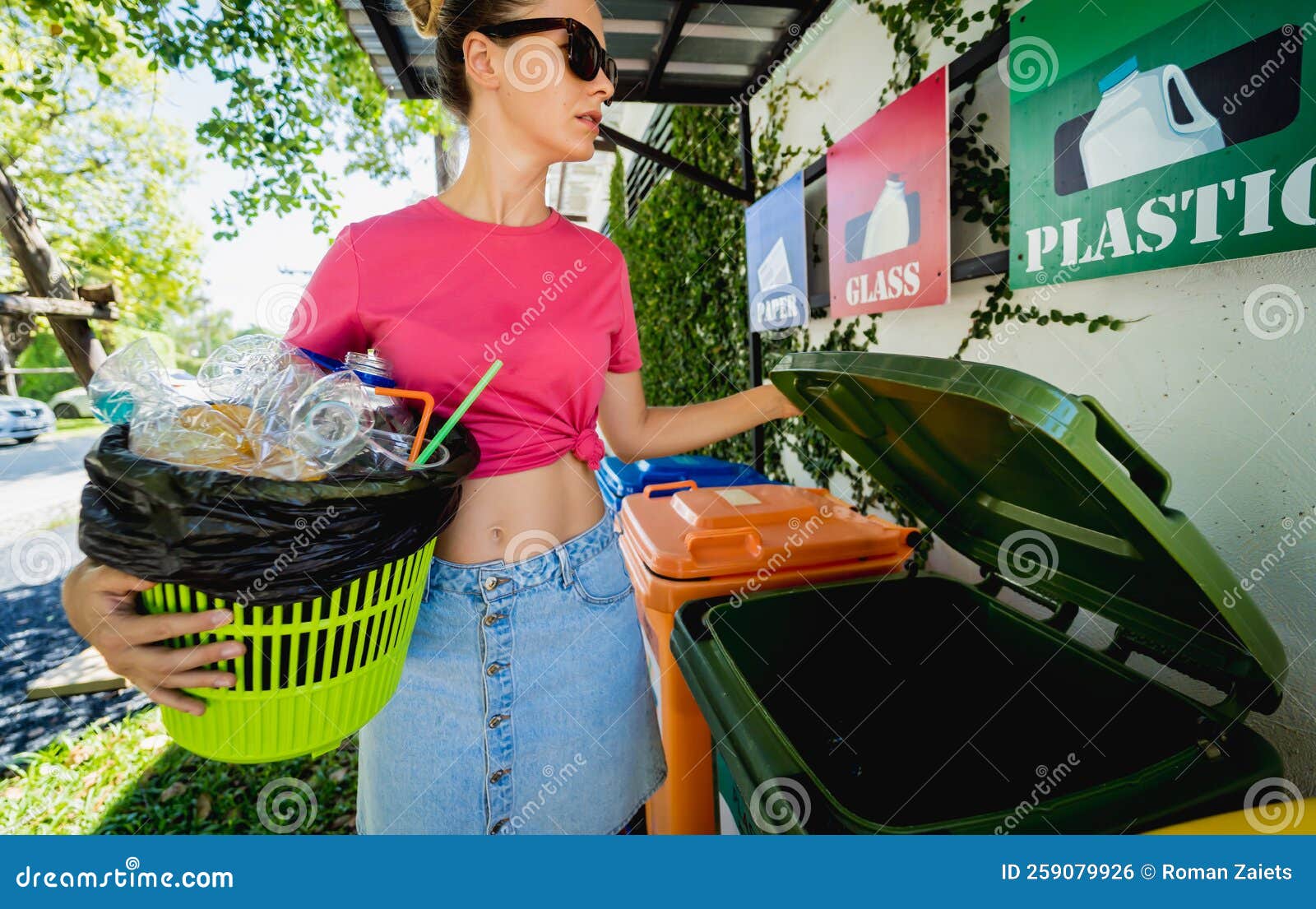 A Young Beautiful Girl Throws Sorted Garbage into Special Bins Stock ...