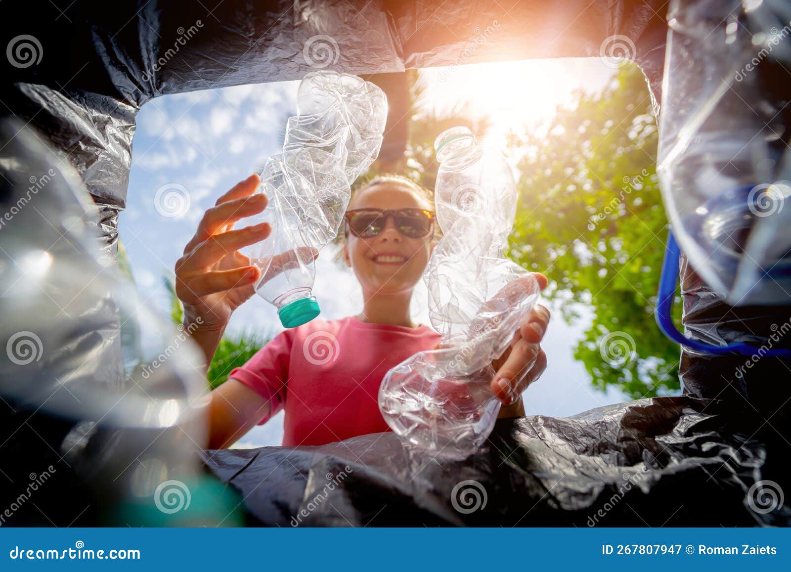 A Young Beautiful Girl Throws Sorted Garbage into Special Bins Stock ...