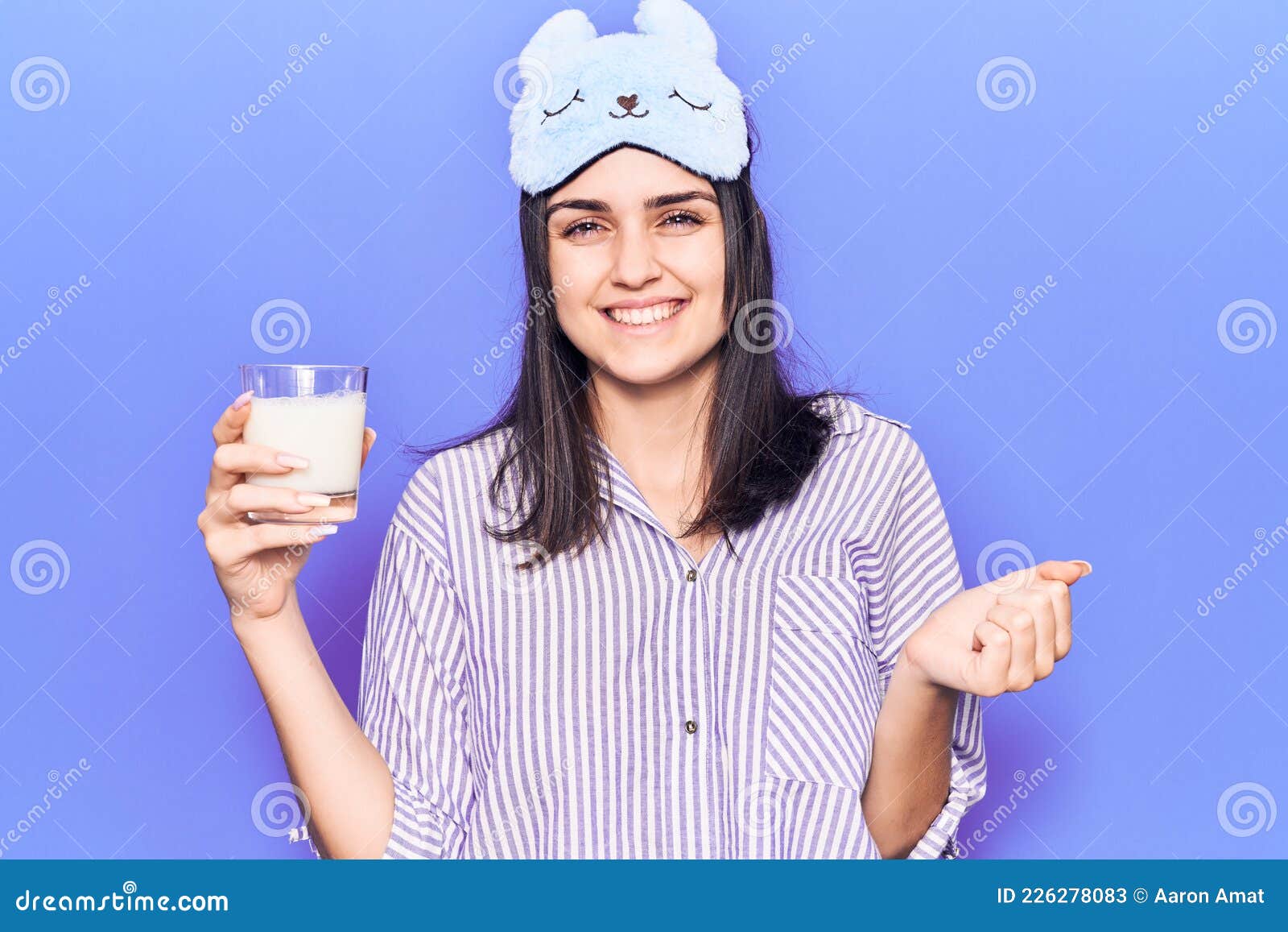 Young Beautiful Girl Wearing Funny Sleep Mask Drinking Milk Screaming