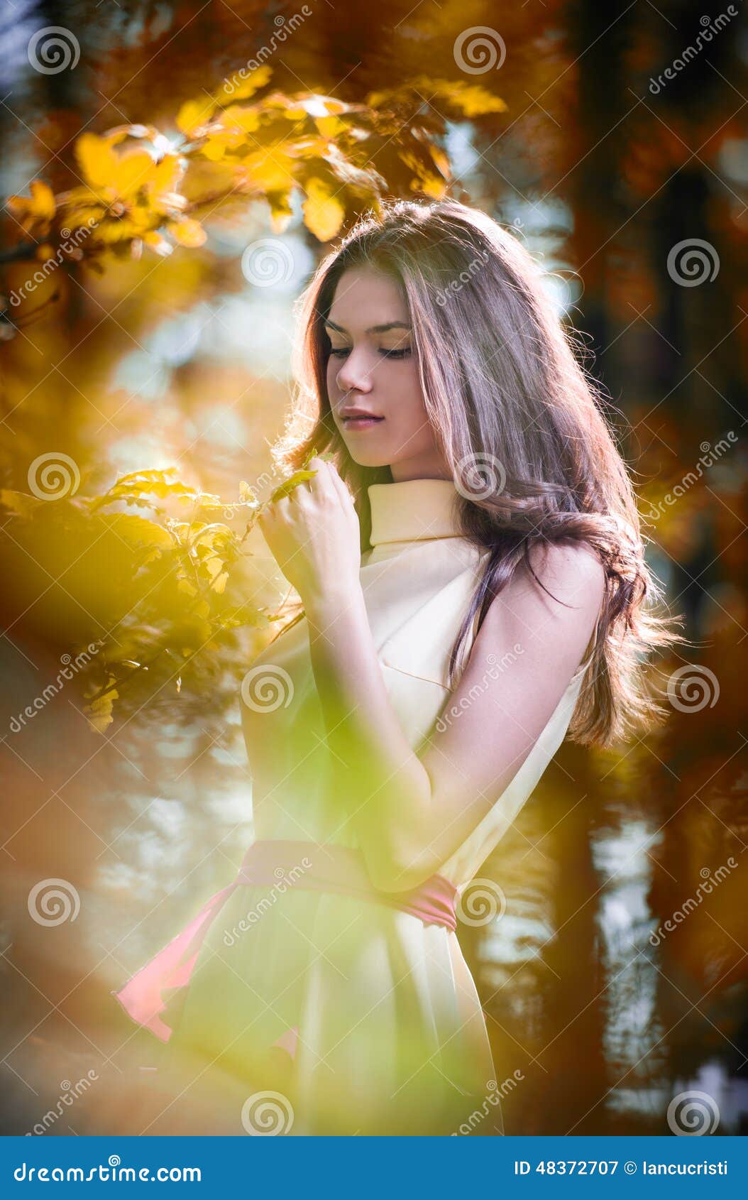 Young Beautiful Girl In A Yellow Dress In The Woods Portrait Of