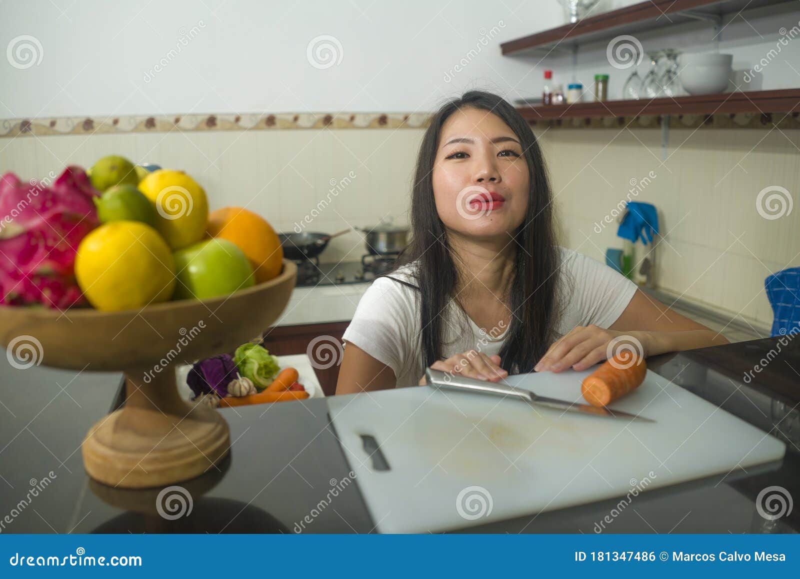 Young Beautiful And Happy Asian Chinese Woman At Home Kitchen Relaxed
