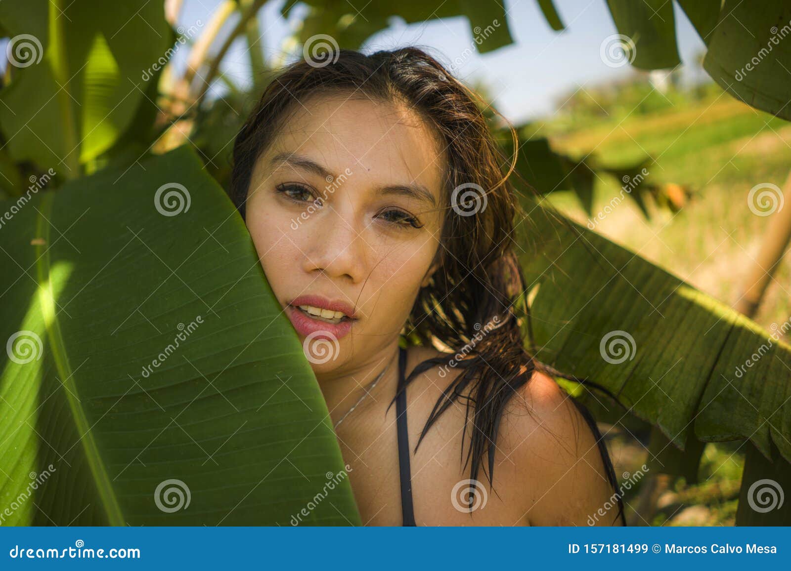 Young Beautiful And Happy Asian Indonesian Woman In Bikini Posing