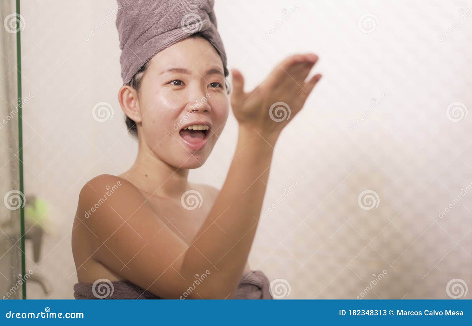 Young Beautiful And Happy Asian Korean Woman With Head Wrapped In Towel