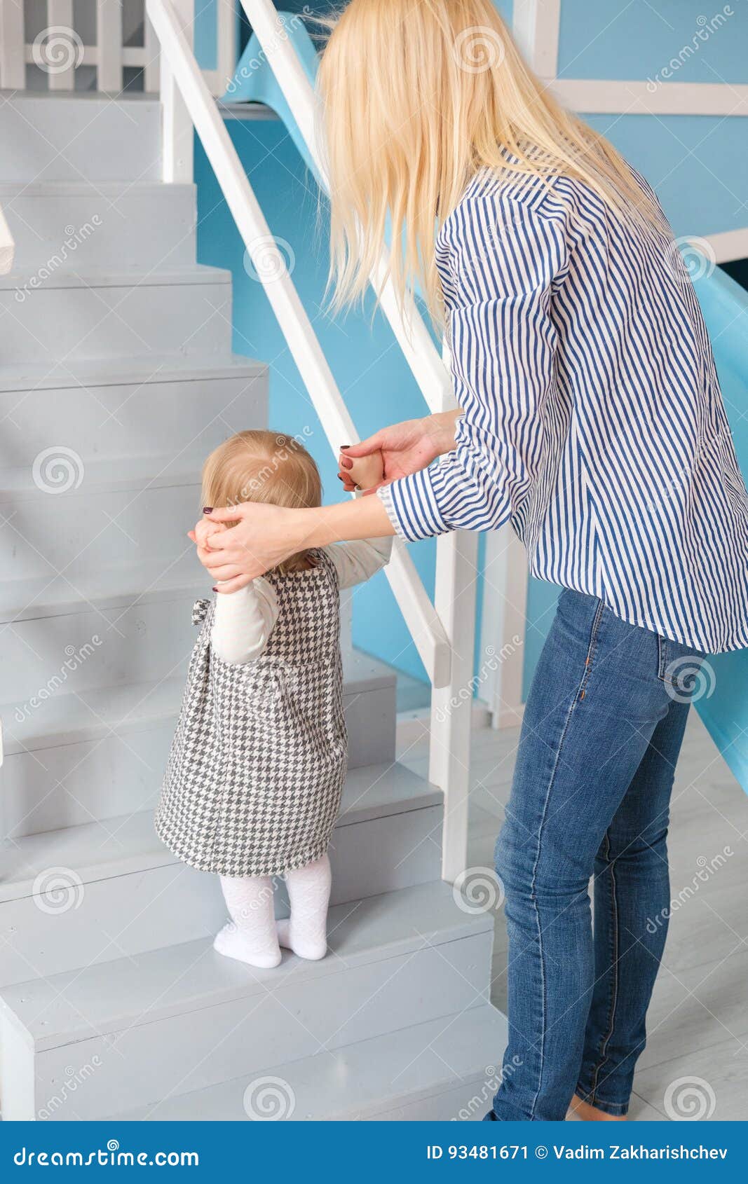Young Beautiful Happy Mother Help Her Daughter Doing Her First Step ...
