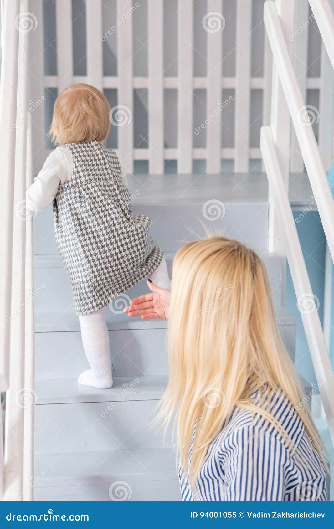 Young Beautiful Happy Mother Help Her Daughter Doing Her First Step ...