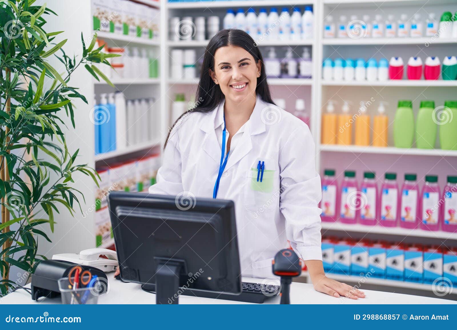 Young Beautiful Hispanic Woman Pharmacist Smiling Confident Using ...
