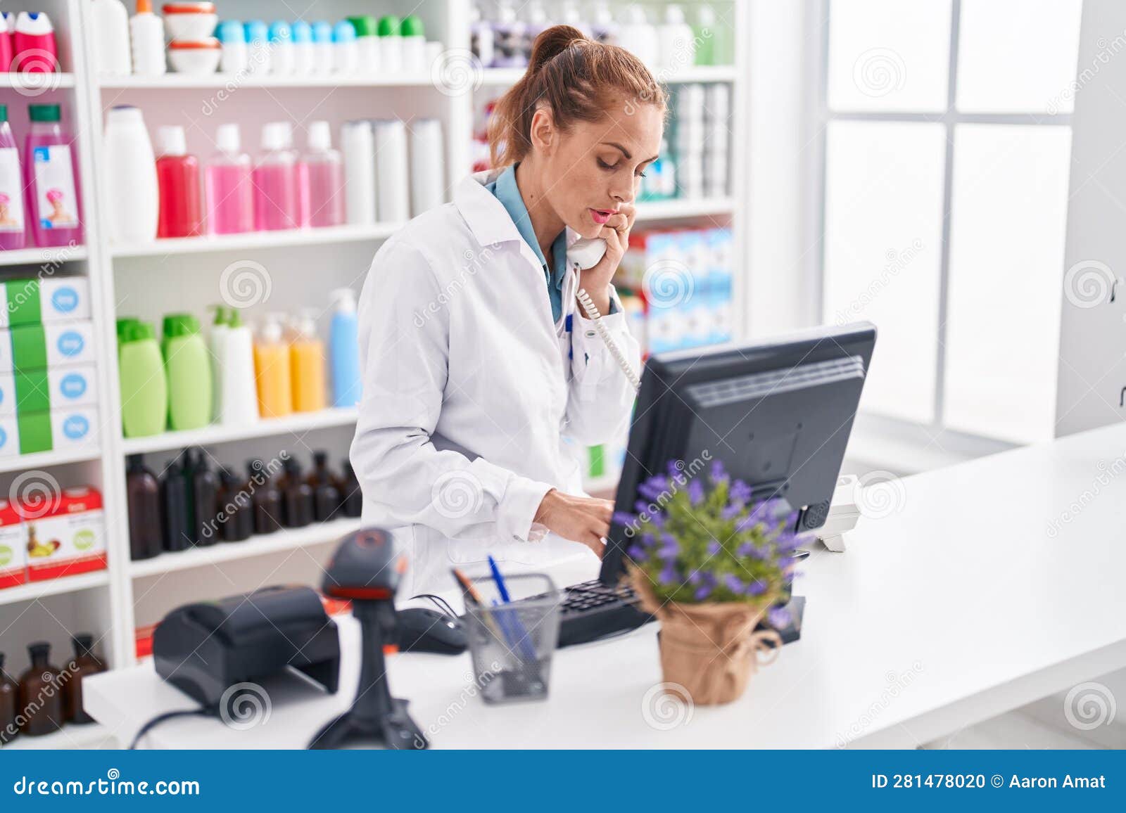 Young Beautiful Hispanic Woman Pharmacist Talking on Telephone Using ...