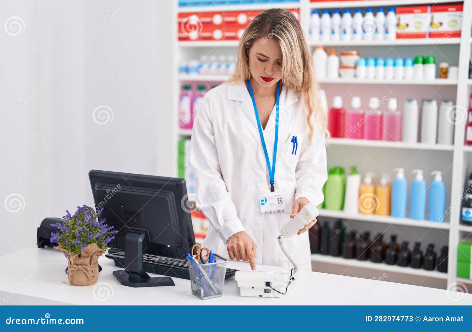 Young Beautiful Hispanic Woman Pharmacist Talking on Telephone Using ...