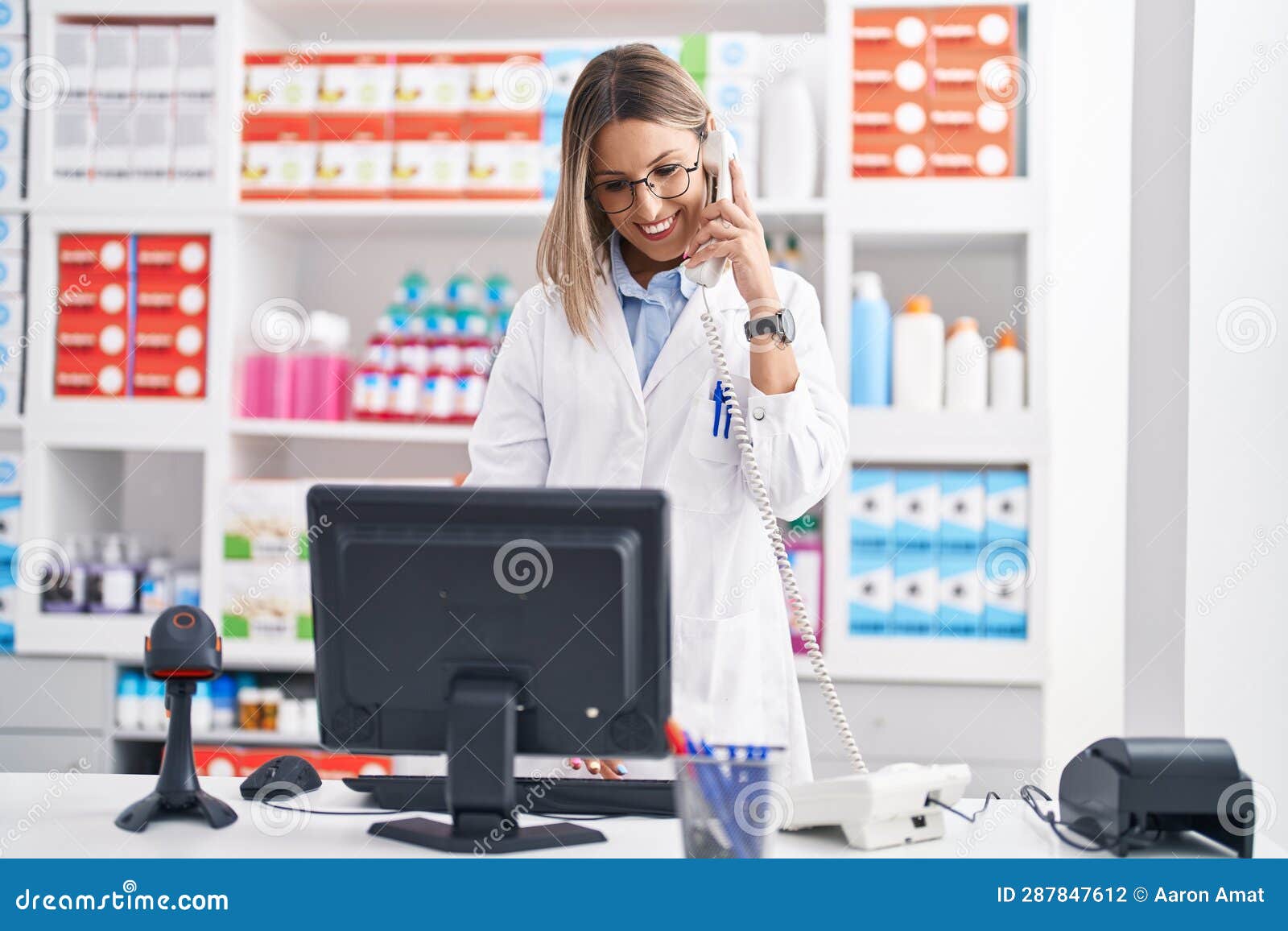 Young Beautiful Hispanic Woman Pharmacist Talking on Telephone Using ...