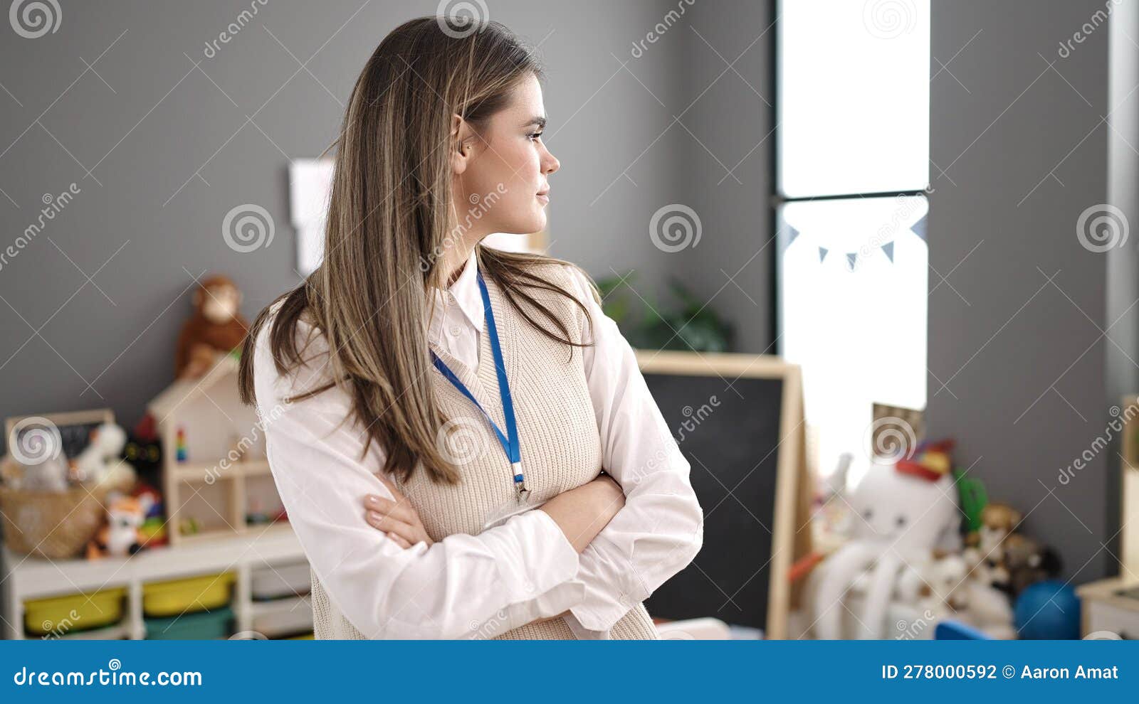 Young Beautiful Hispanic Woman Preschool Teacher Standing With Crossed