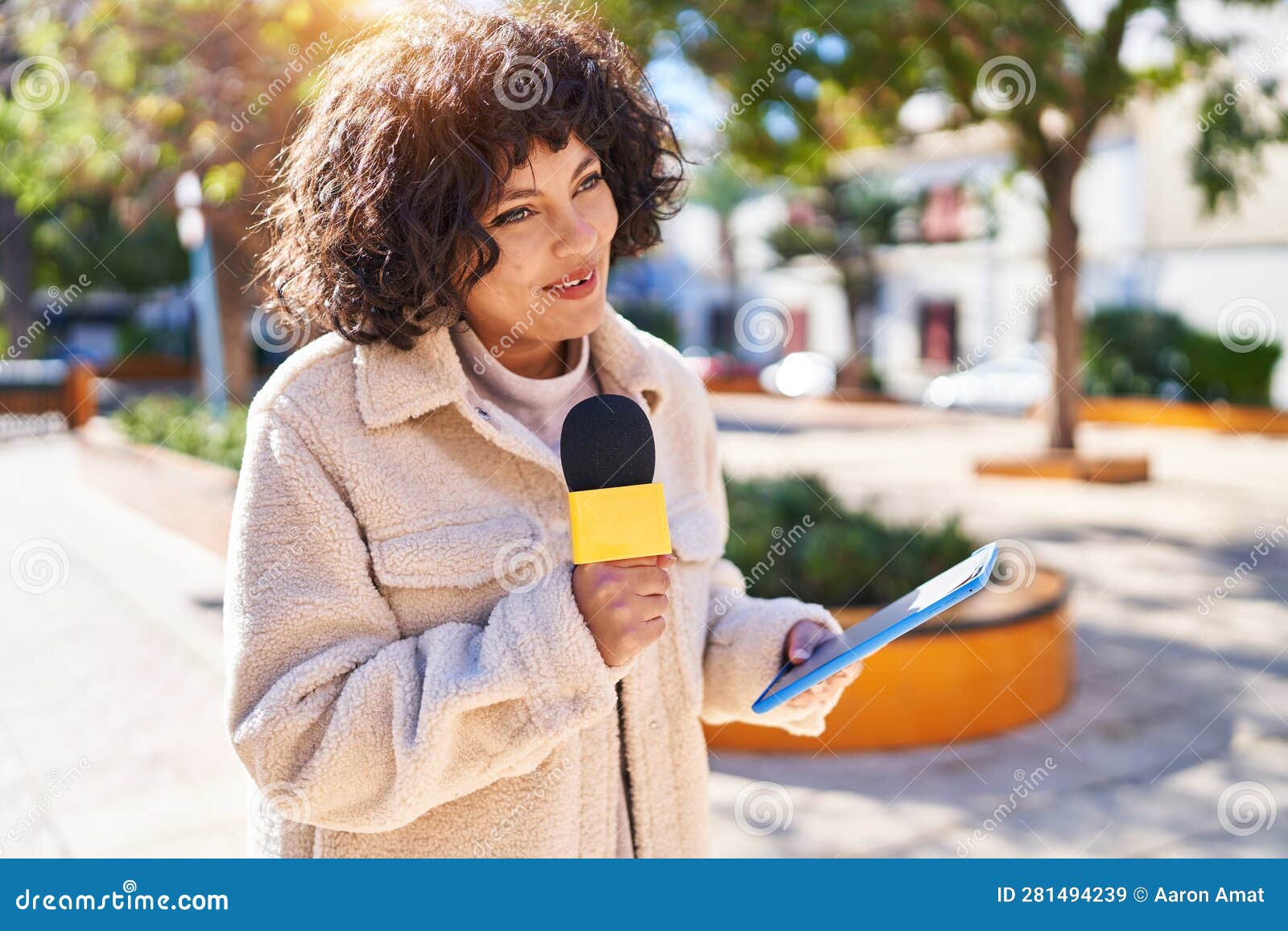 Young Beautiful Hispanic Woman Reporter Working Using Microphone and ...