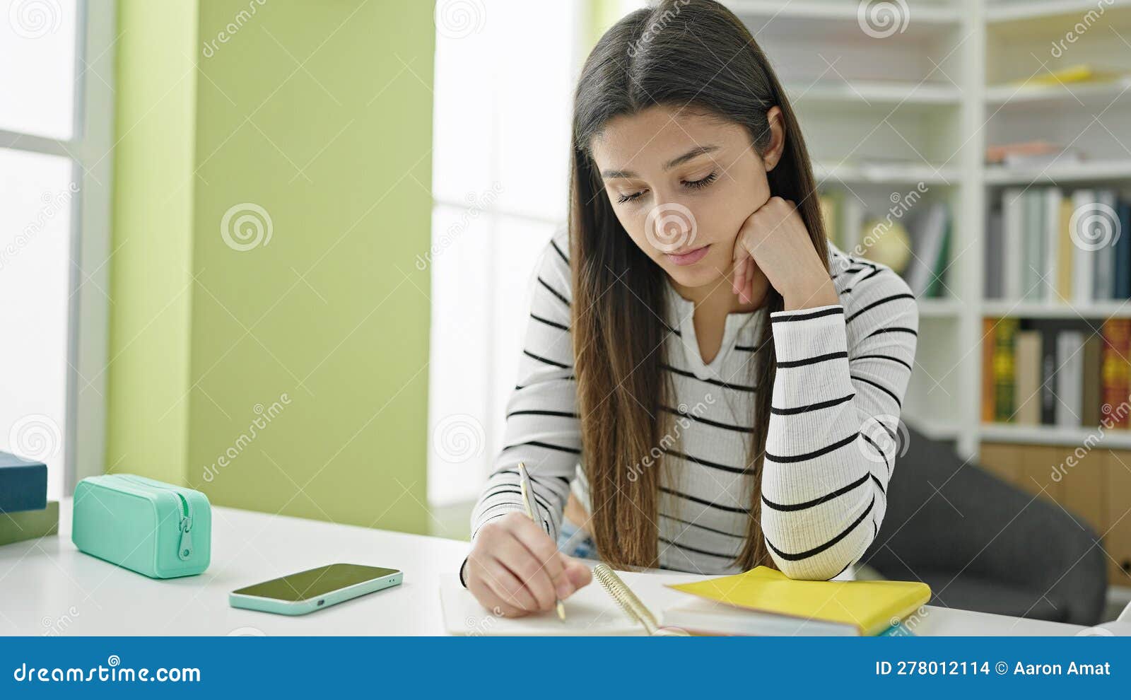 Young Beautiful Hispanic Woman Student Writing Notes at Library ...