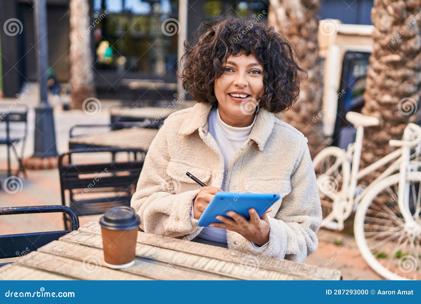 Young Beautiful Hispanic Woman Using Touchpad Sitting on Table at ...