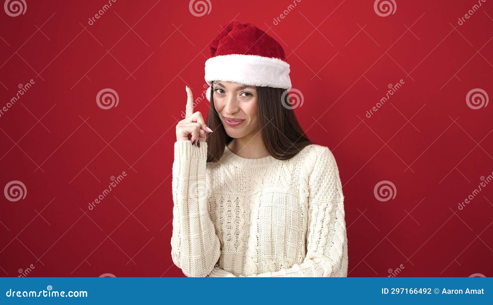 Young Beautiful Hispanic Woman Wearing Christmas Hat With Idea
