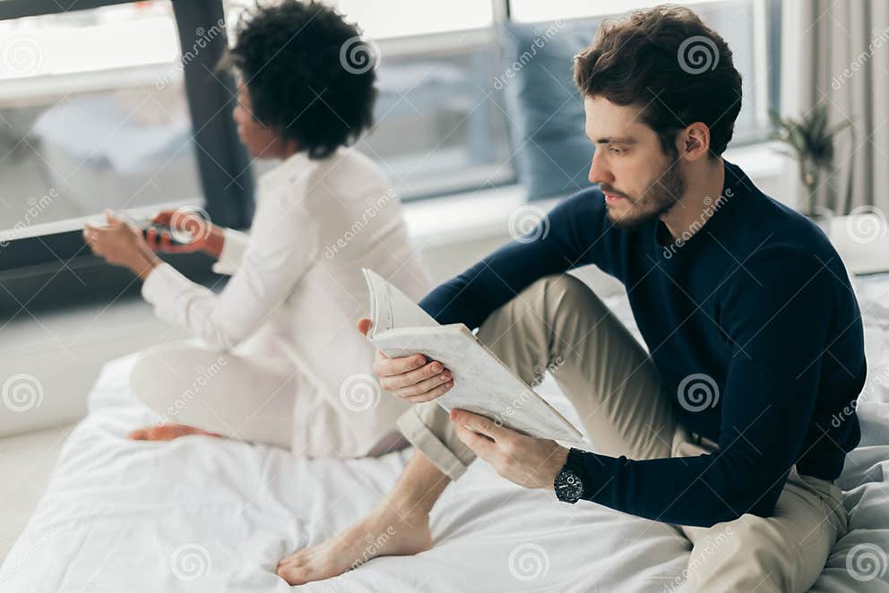Young Beautiful Interracial Couple In Bed Stressed With Infidelity