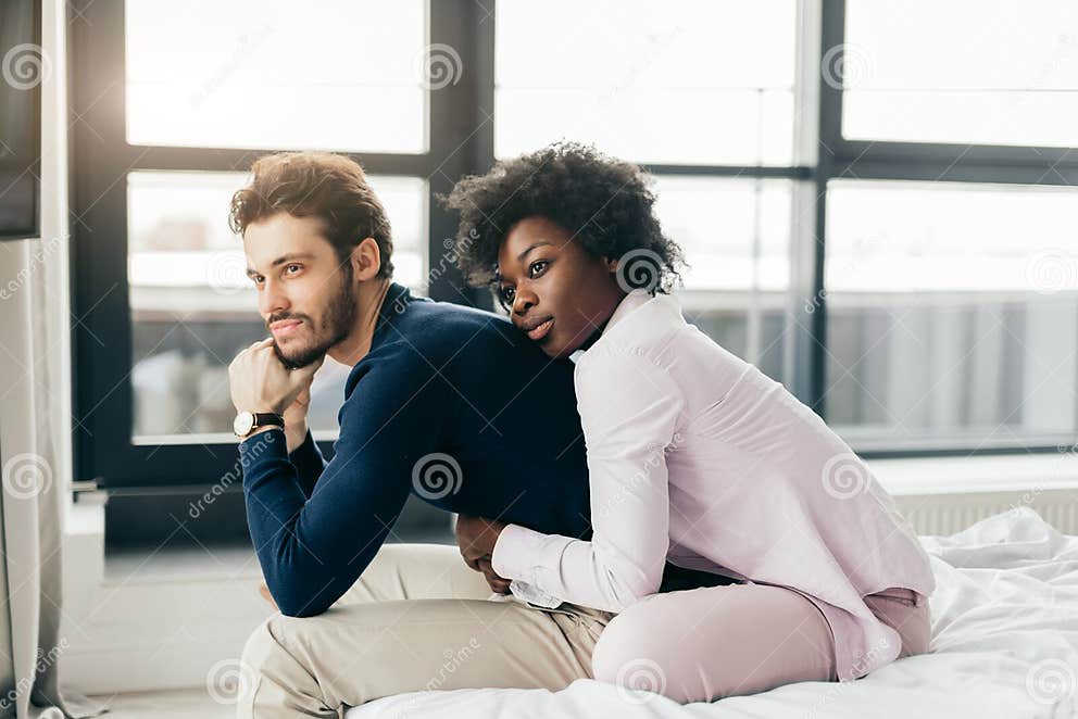 Young Beautiful Interracial Couple In Bed Stressed With Infidelity