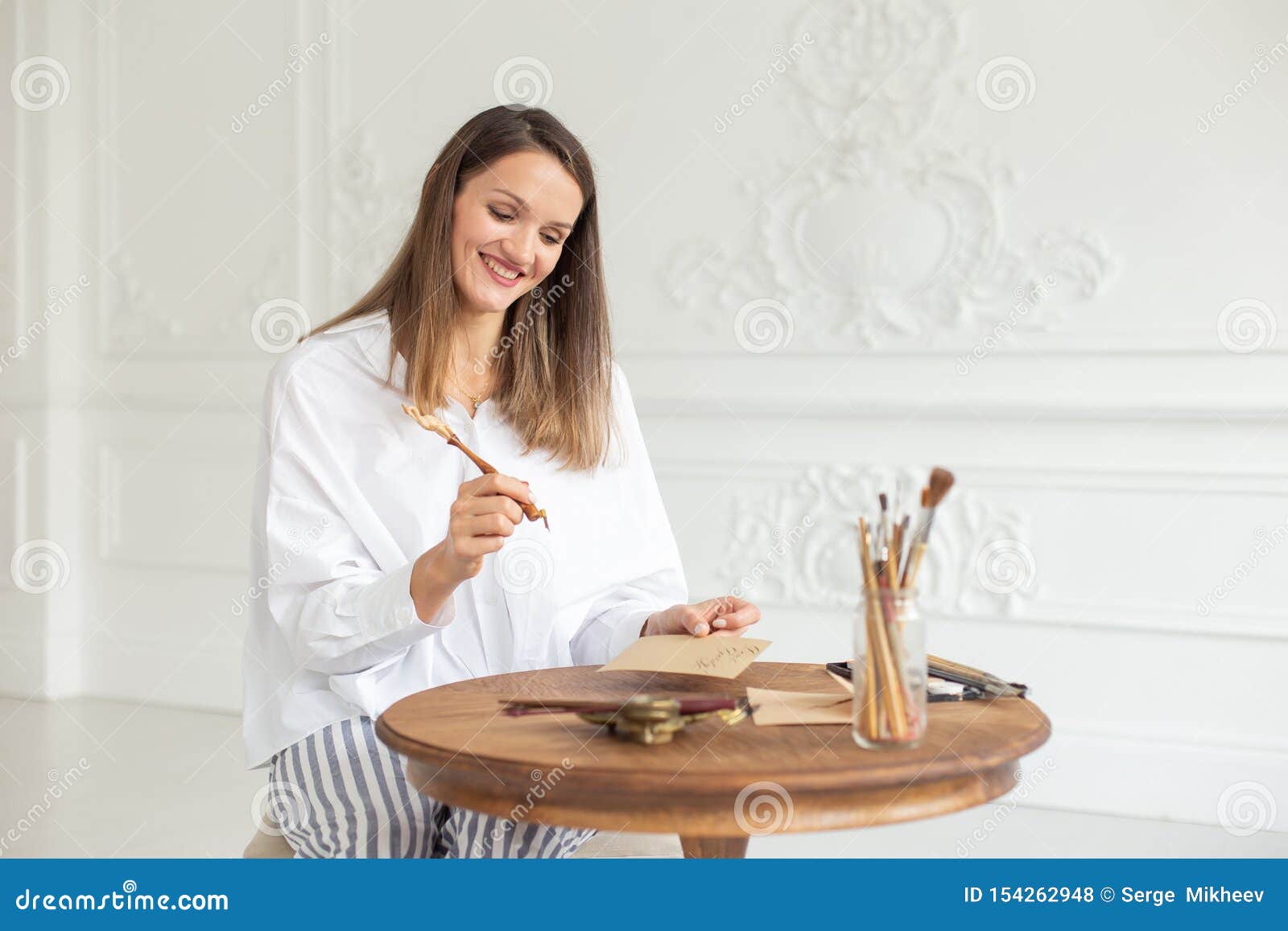 Young Beautiful Smiling Calligrapher Girl Working in a Workshop on a ...