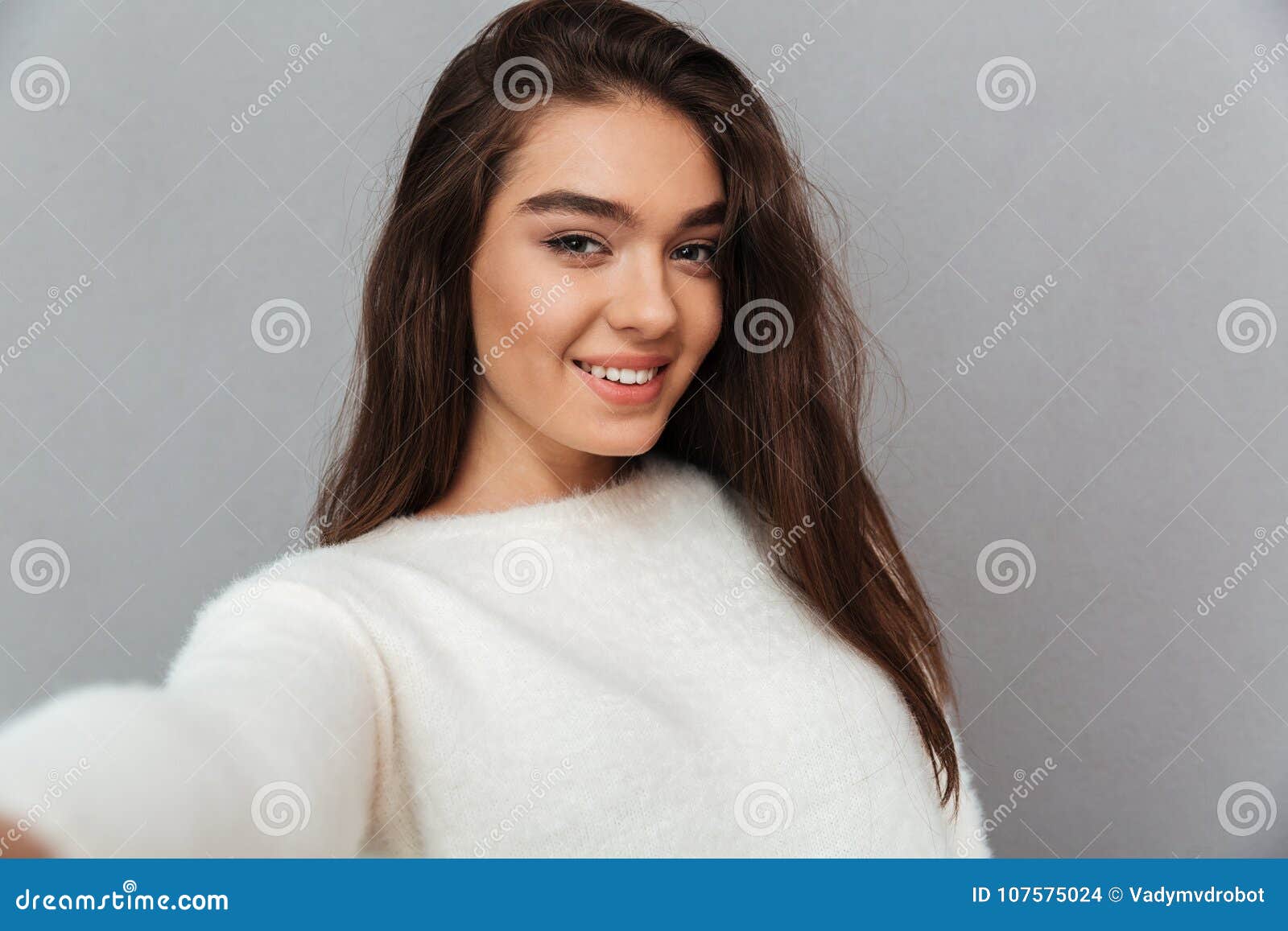 Young Beautiful Smiling Woman In White Soft Sweater Taking Selfi Stock
