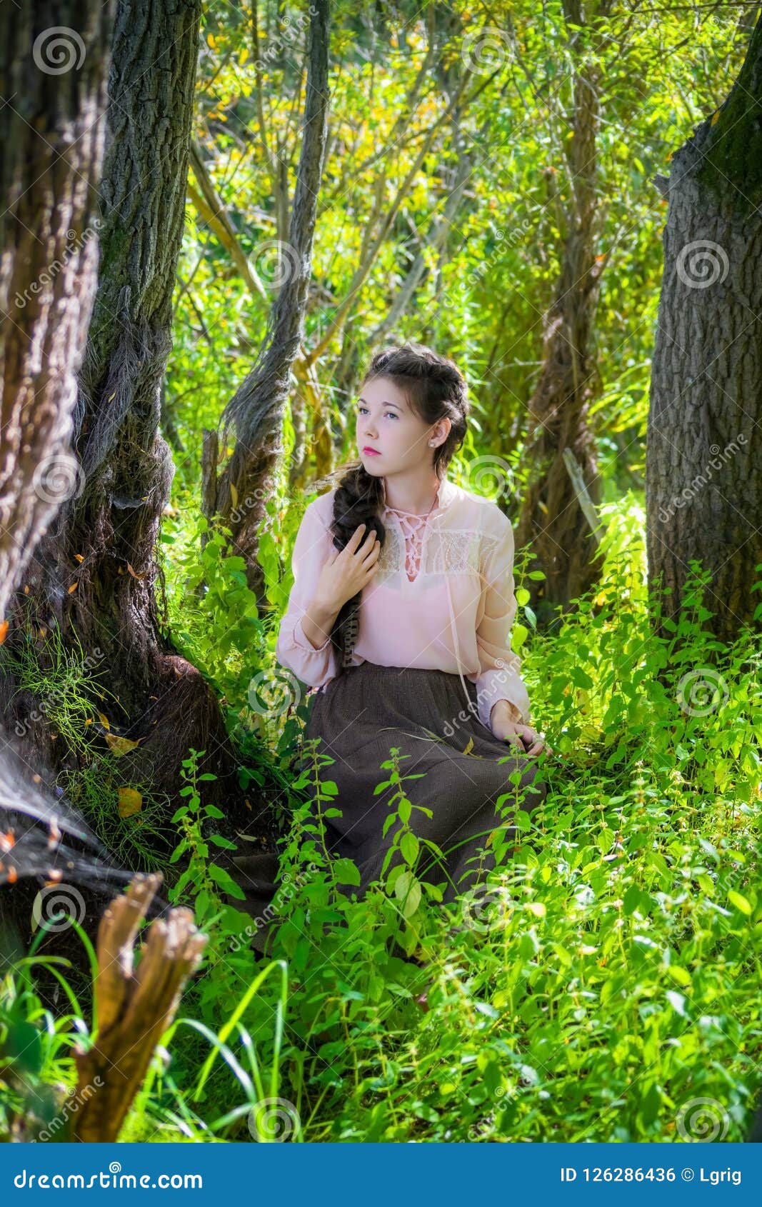 Girl Sits Under a Tree in the Forest. Stock Photo - Image of meditation ...