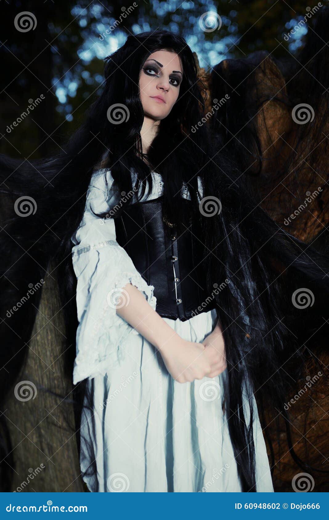 Young Beautiful Witch with Long Dark Hair in Root of Old Tree Stock ...
