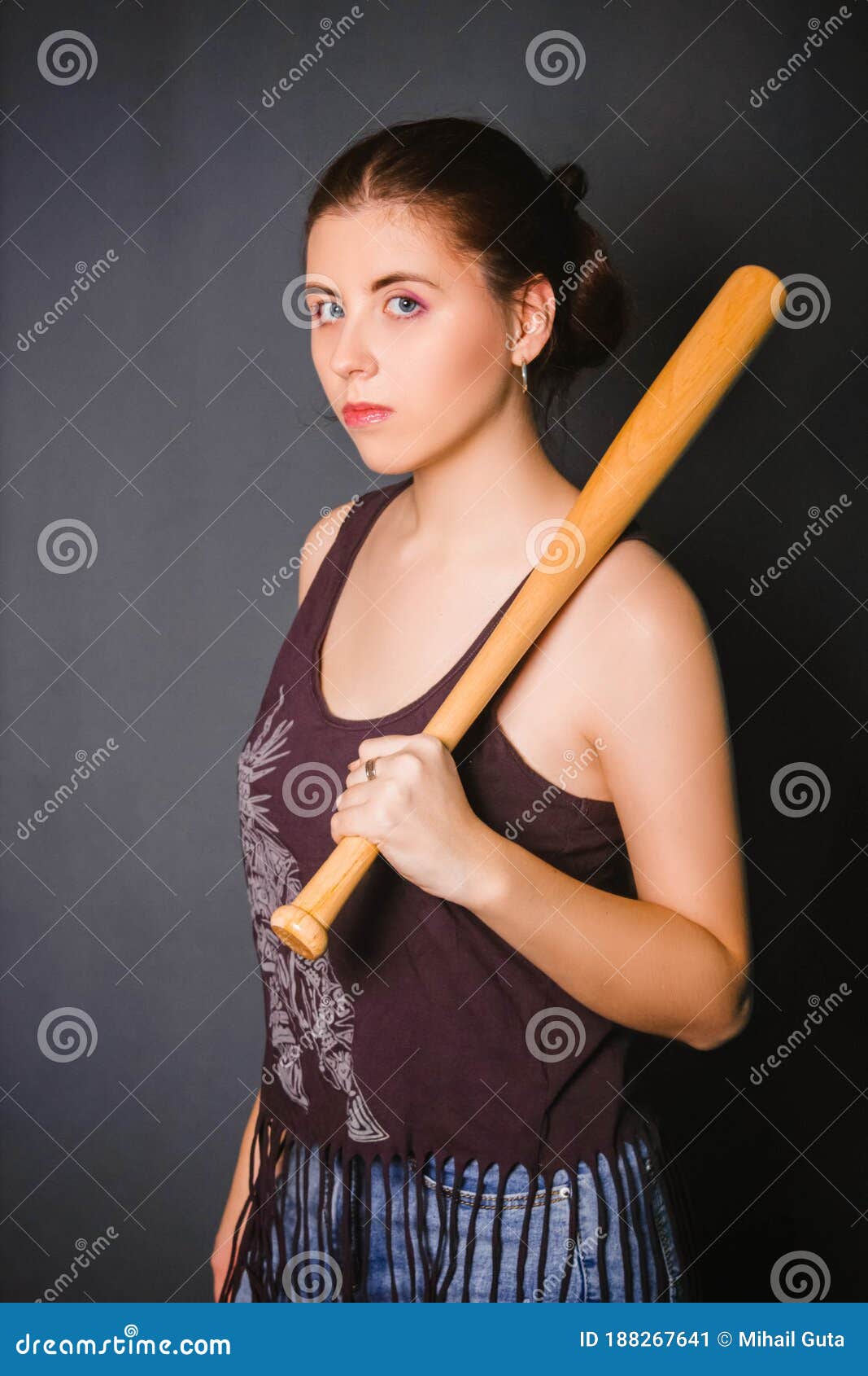 Young Beautiful Woman With A Baseball Bat In Her Hands Fashionable