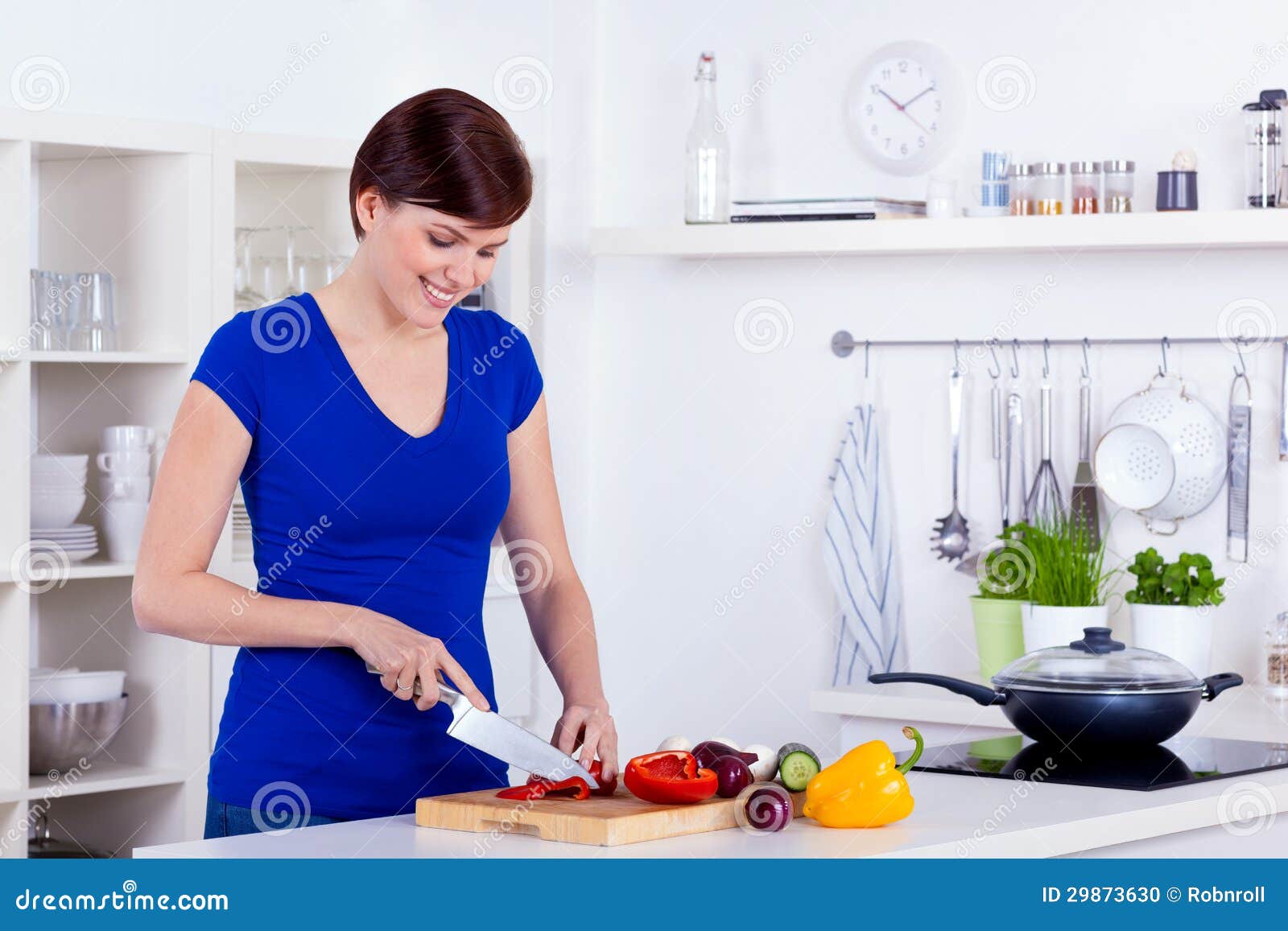 Beautiful Woman is Chopping Vegetables in Her Modern Kitchen Stock ...
