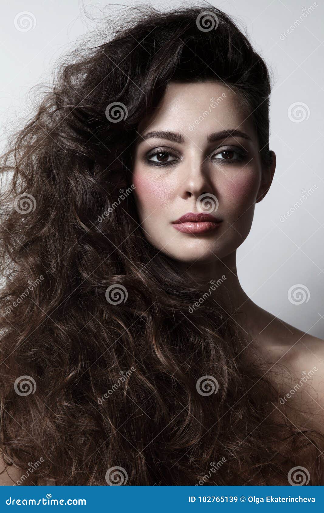 Beautiful Woman With Curly Hair And Smoky Eye Make Up Stock Image